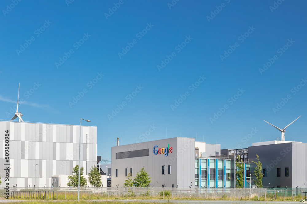 Entrance view of a Google data center in front of a clear blue sky in ...