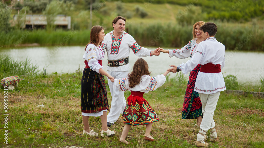 Full length image of a family with kids in traditional romanian dress ...