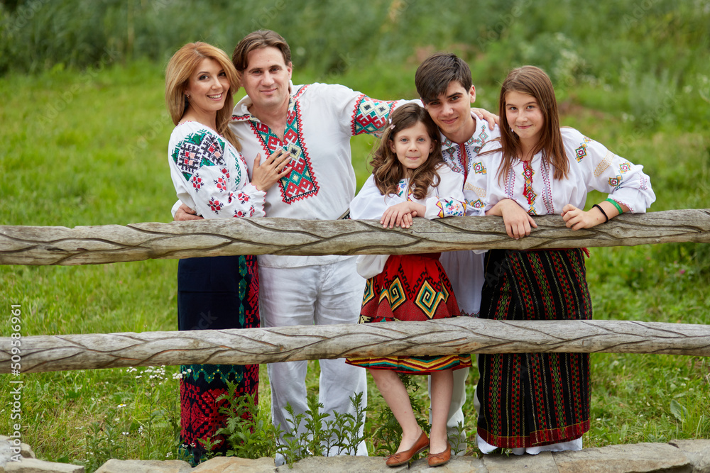 Cheerful family with kids in traditional romanian dress in a ...