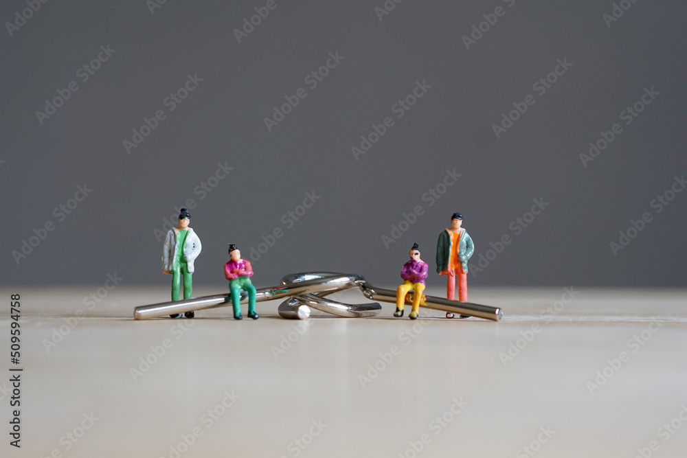 Miniature figurine character: two people sitting on Yin and Yang puzzle ...