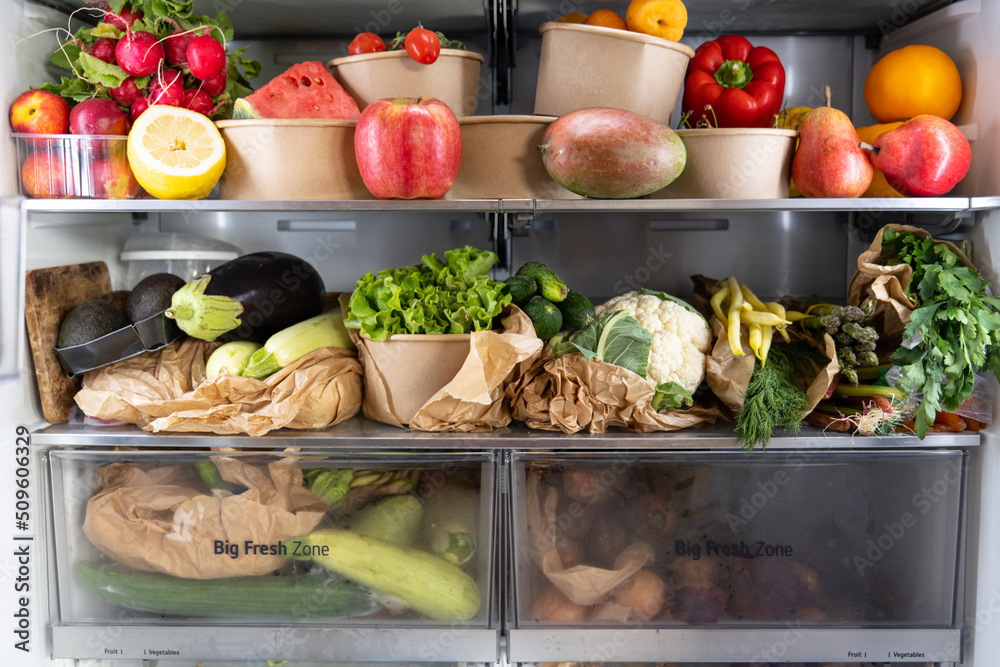 Opened refrigerator full of vegetarian healthy fresh fruit, vegetables ...