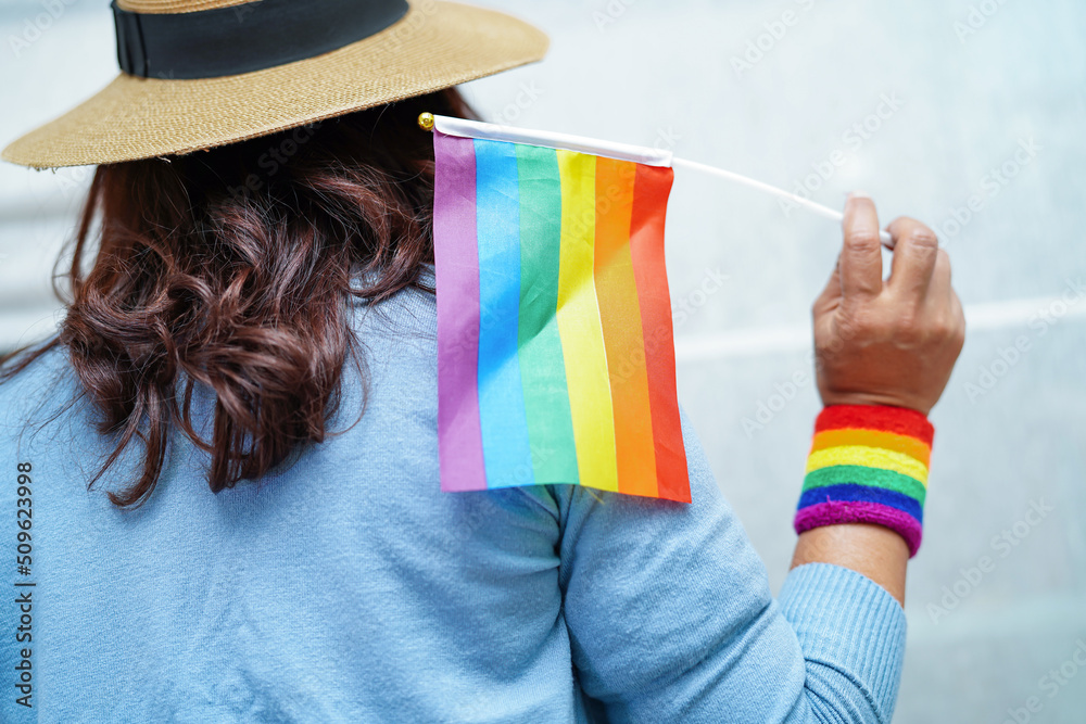 Asian lady holding rainbow color flag, symbol of LGBT pride month ...