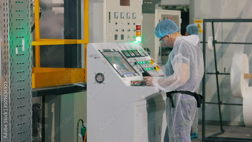 Workers in a modern factory. People perform work in the workshop of a ...