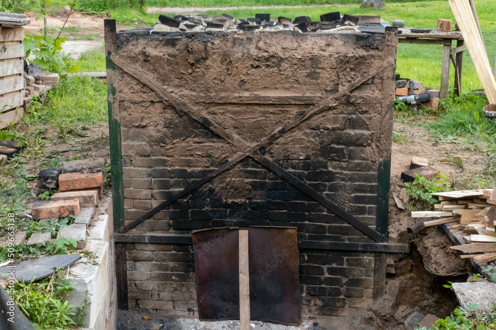 Firing of wood fire kiln is part of process for black pottery. Unique ...