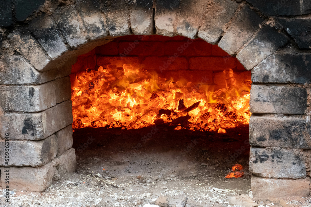 Firing of wood fire kiln is part of process for black pottery. Unique ...
