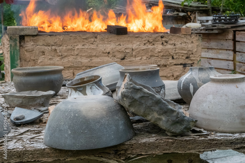 Firing of wood fire kiln is part of process for black pottery. Unique ...