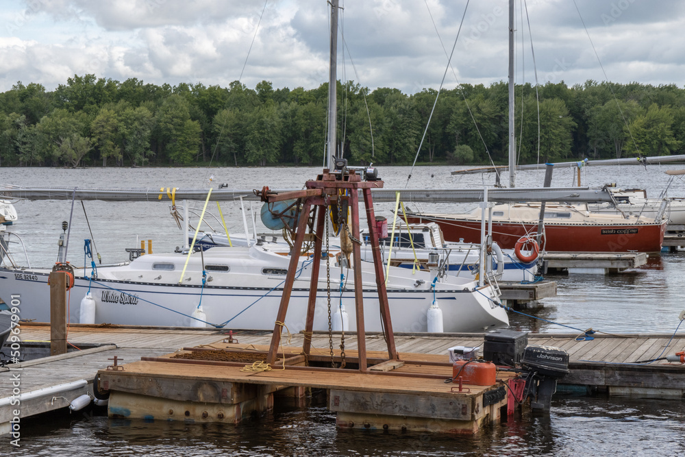 Homemade motorized raft with outboard motor carrying a steel frame ...