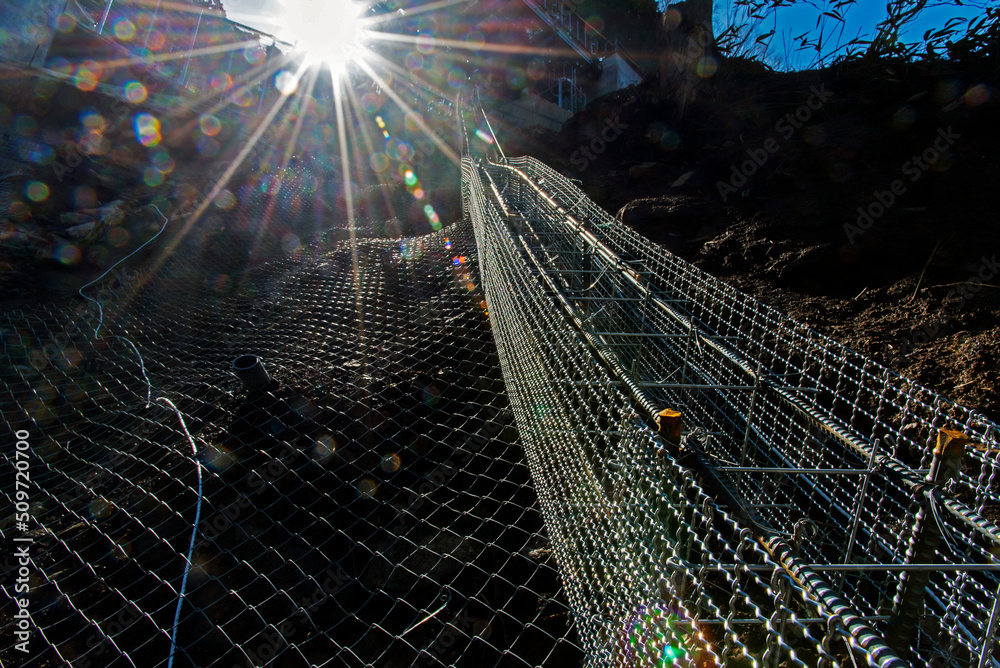 Japanese slope protection work, Reinforcing bars covered in a mesh to ...