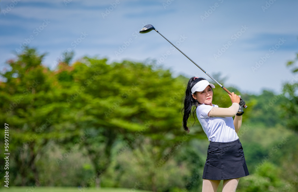 Professional woman golfer teeing golf in golf tournament competition at ...