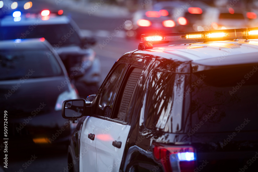Police units pull over a car on a city street. Stock Photo | Adobe Stock