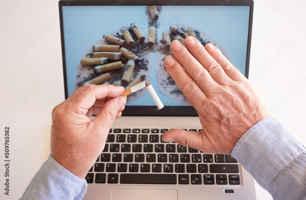 World no tobacco day. Caucasian male hands holding a broken cigarette ...