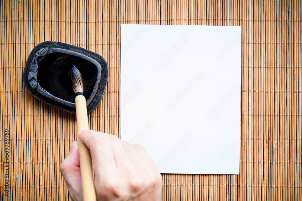 Abstract man hand hold calligraphy brush with white paper and and ...