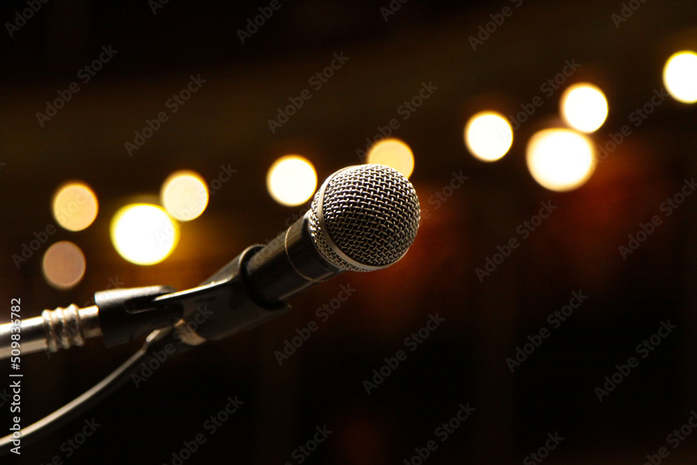 Microphone. Stage with a microphone and background lights. Dark ...