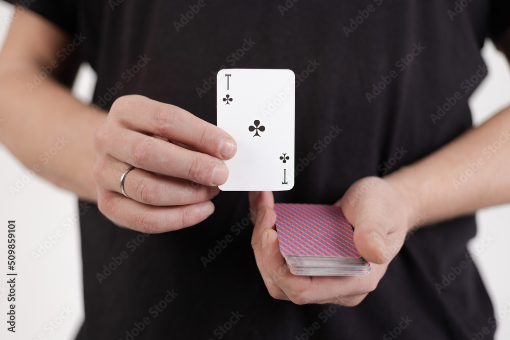 Male hands hold a deck of cards and show tricks. The photographer is ...