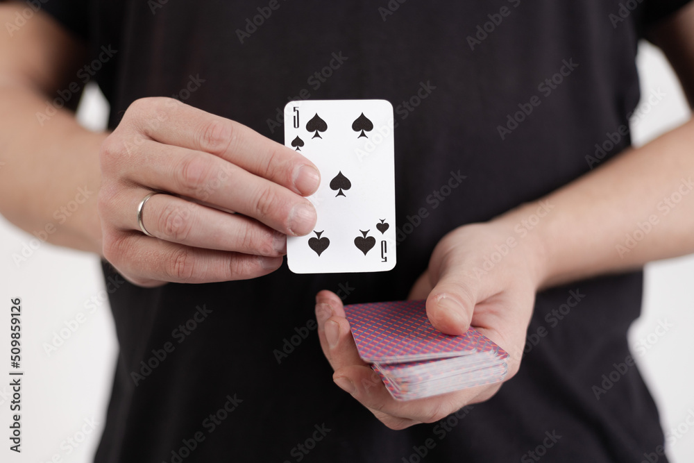 Male hands hold a deck of cards and show tricks. The photographer is ...