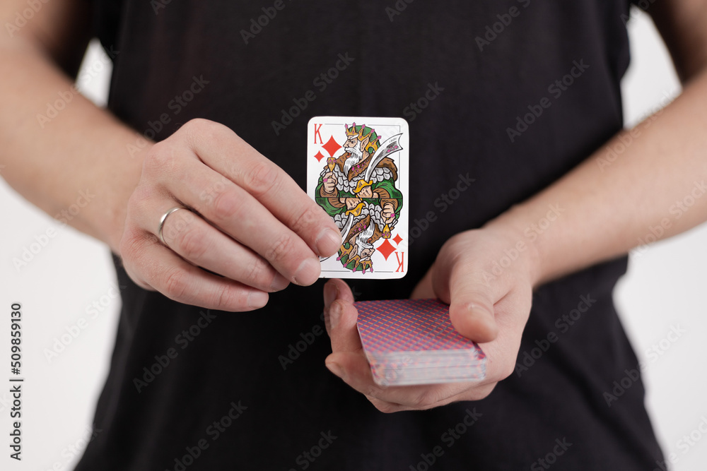 Male hands hold a deck of cards and show tricks. The photographer is ...