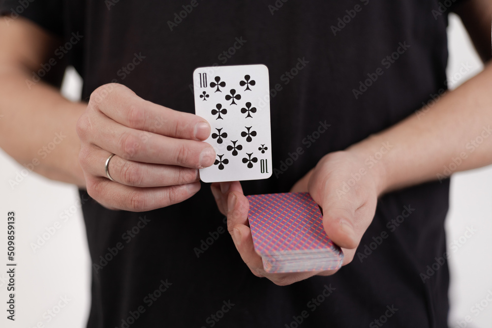 Male hands hold a deck of cards and show tricks. The photographer is ...