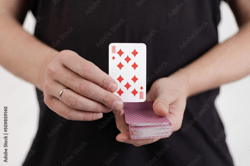 Male hands hold a deck of cards and show tricks. The photographer is ...