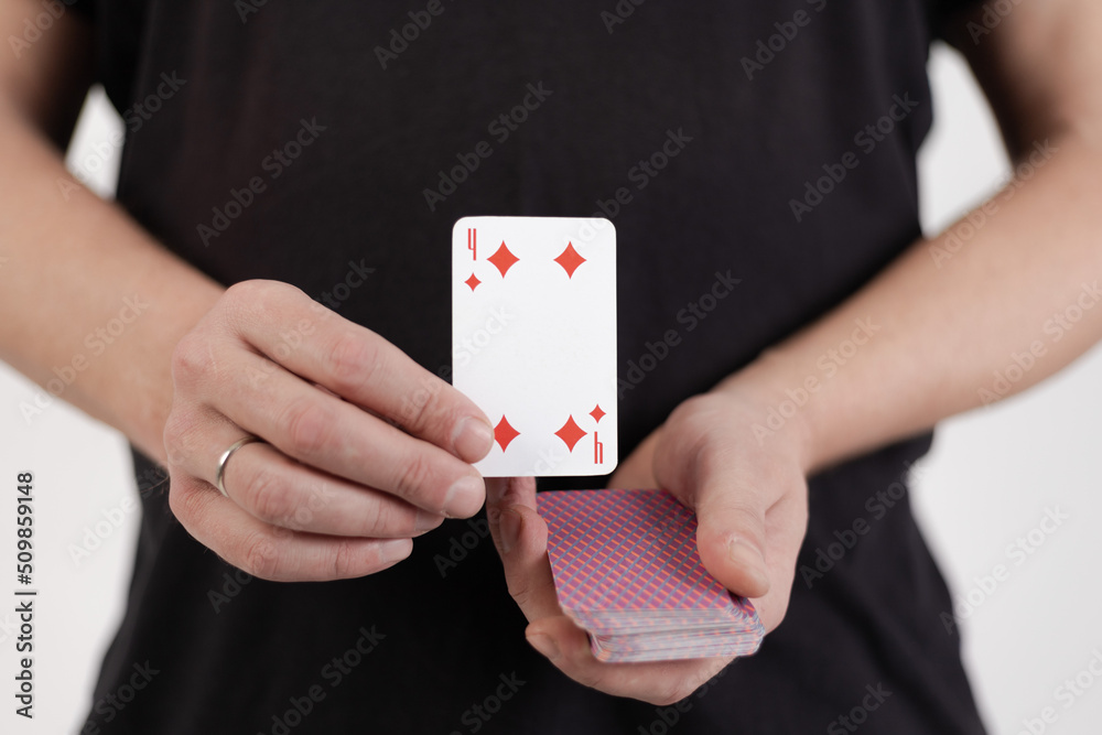 Male hands hold a deck of cards and show tricks. The photographer is ...