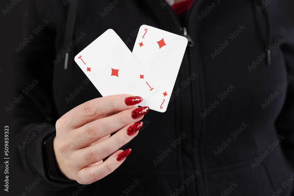 Female hands hold a deck of cards and show tricks. The photographer is ...