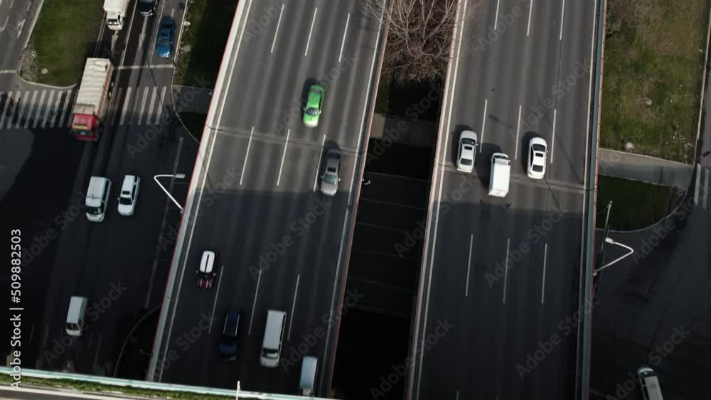 Top down drone aerial flying over modern multileveled intersection ...
