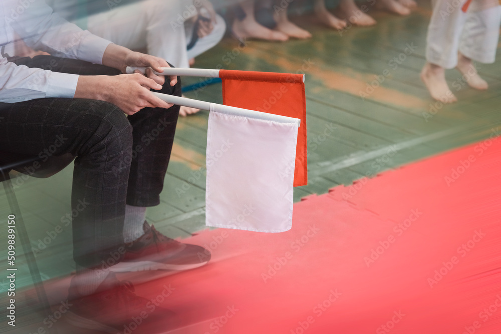 Karate referee with red and white flags at the competition. Stock Photo ...