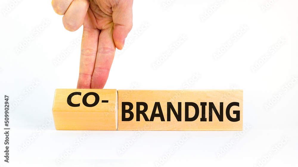 Branding or co-branding symbol. Businessman turns wooden cubes and ...