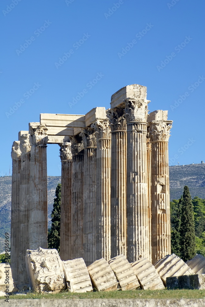 Ancient columns with lintels, and a toppled column at the base, in an ...
