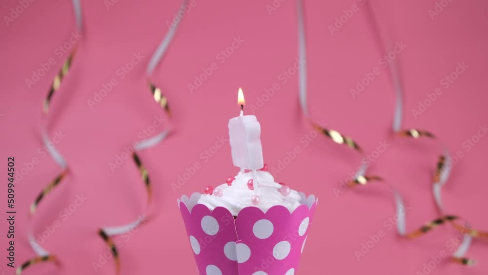 Rotating birthday cake for girls or women or a cupcake with a burning ...