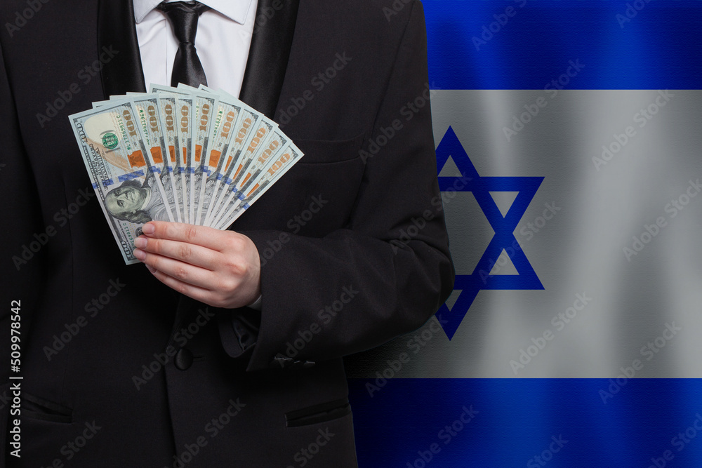 Israeli business man with US 100 dollar bills against flag of Israel ...