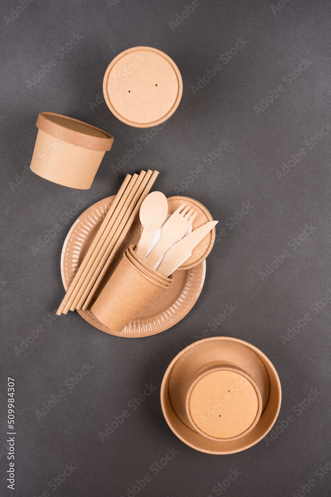 Vertical image of eco paper tableware and utensils - paper cups ...