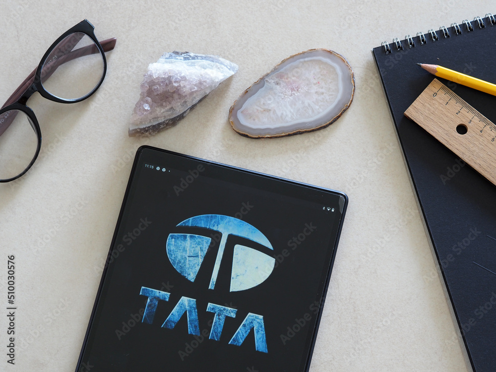 In this photo illustration TATA group logo seen displayed on a tablet ...
