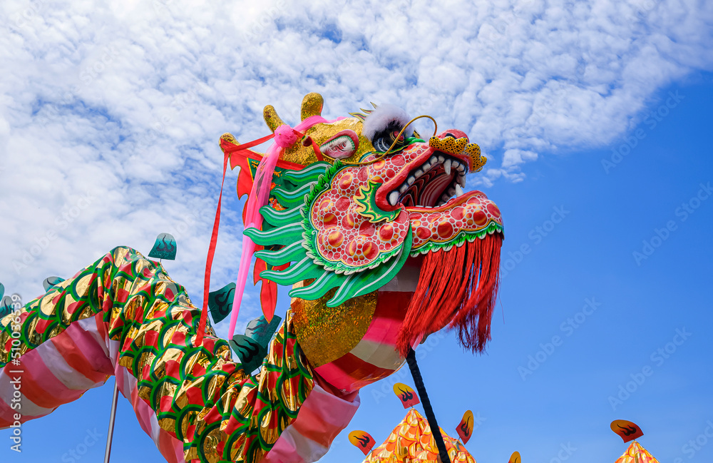 Colorful Chinese dragon dance performances celebration against clouds ...