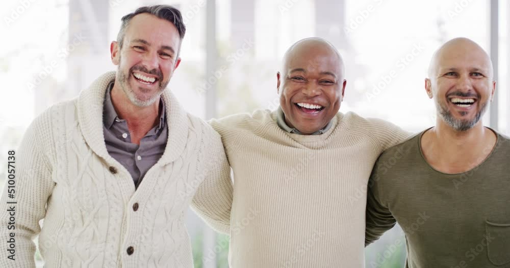 Three diverse men standing together in unity while smiling, laughing ...