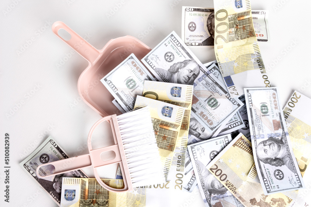 Dustpan, hand brooms and crumpled money dollar bills. Money as garbage ...