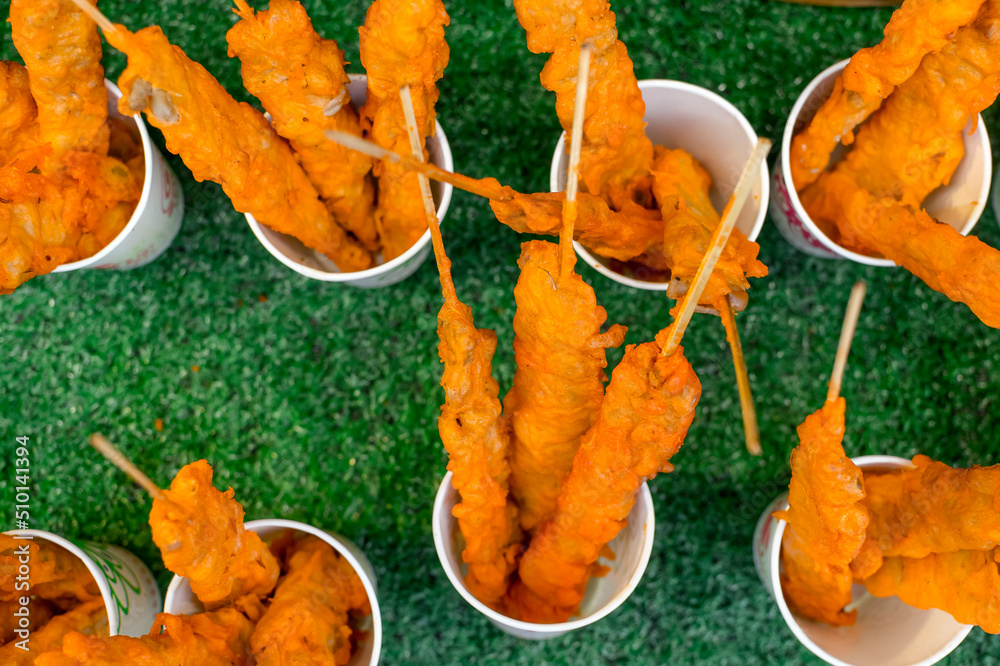 Skewered Breaded fried isaw or small intestine in cups for sale at a ...