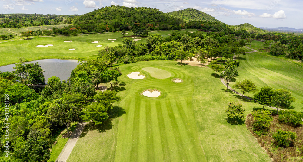 Aerial brid view over of green grass and trees on a golf field, fairway ...