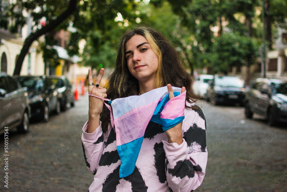 Cool trans girl winking with pride flag portrait Stock Photo | Adobe Stock