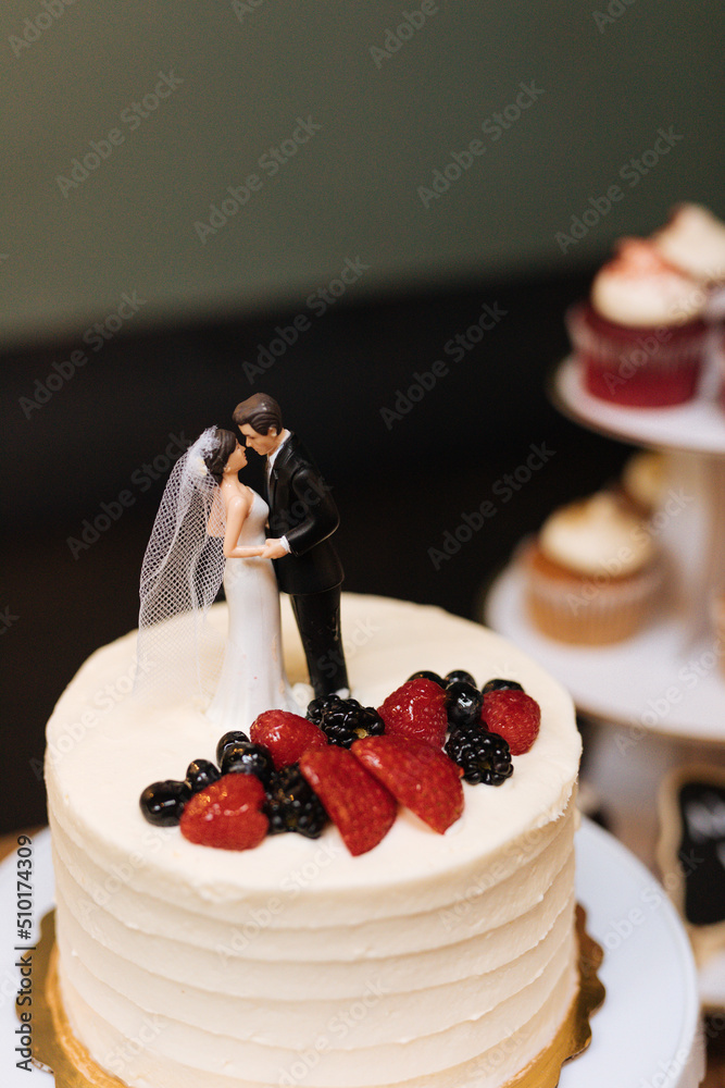White wedding cake with bride and groom Stock Photo | Adobe Stock