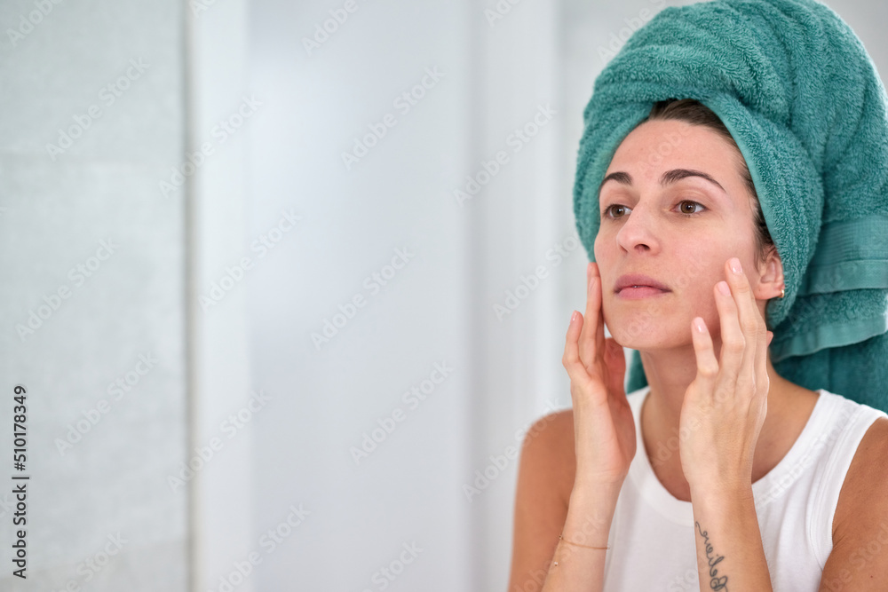 Female smearing cream on cheeks Stock Photo | Adobe Stock