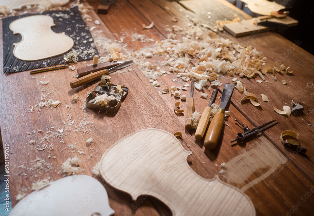 Luthier's work table full of templates, tools and wood shavings Stock ...