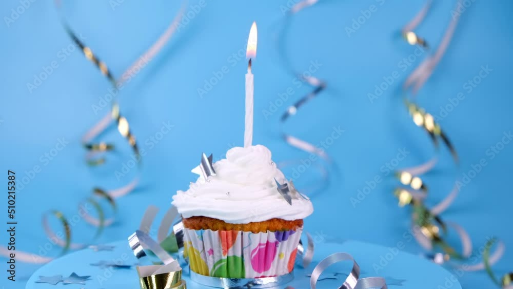Rotating birthday cake for a boy or man or a cupcake with a burning ...