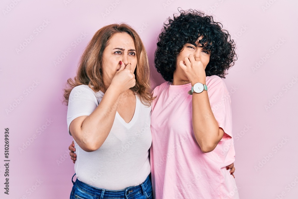 Middle east mother and daughter wearing casual clothes smelling ...