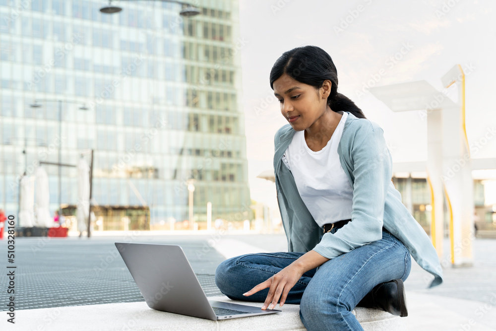Indian student using laptop computer studying, watching videos sitting ...