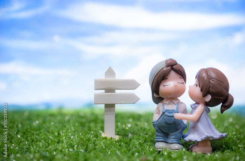 Miniature doll couple boy and girl kissing each other with love at the ...