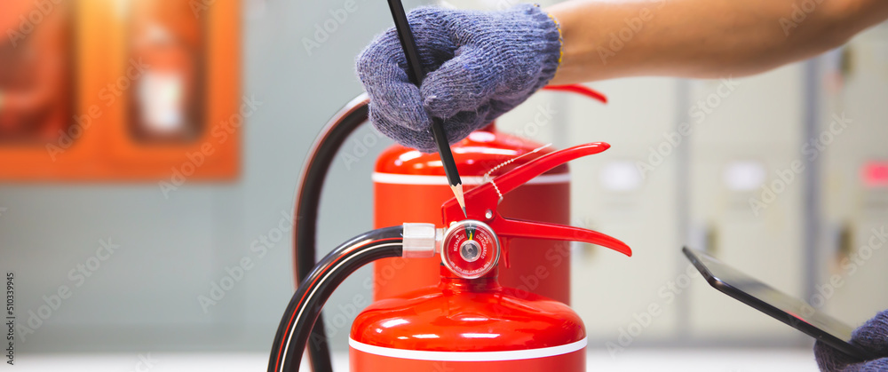 Fire extinguisher has hand engineer inspection checking pressure gauges ...