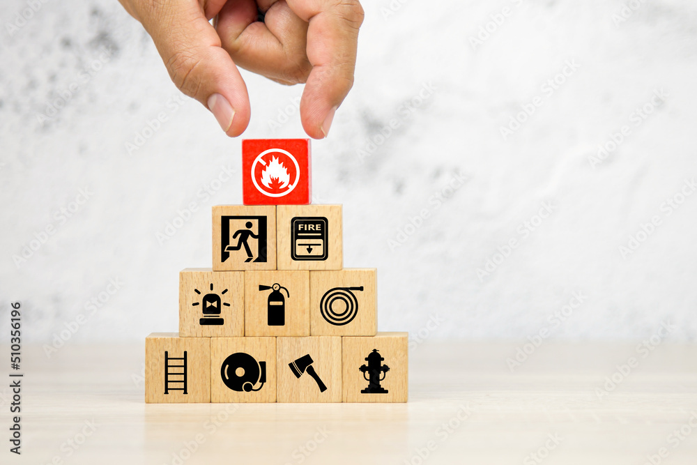 Hand choose wooden block stack with fire prevent icon and door exit ...