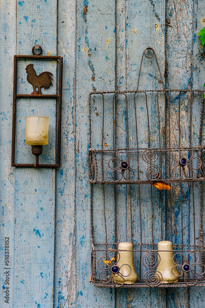 Wrought iron decorations hung on a natural wood panel with the trace of ...