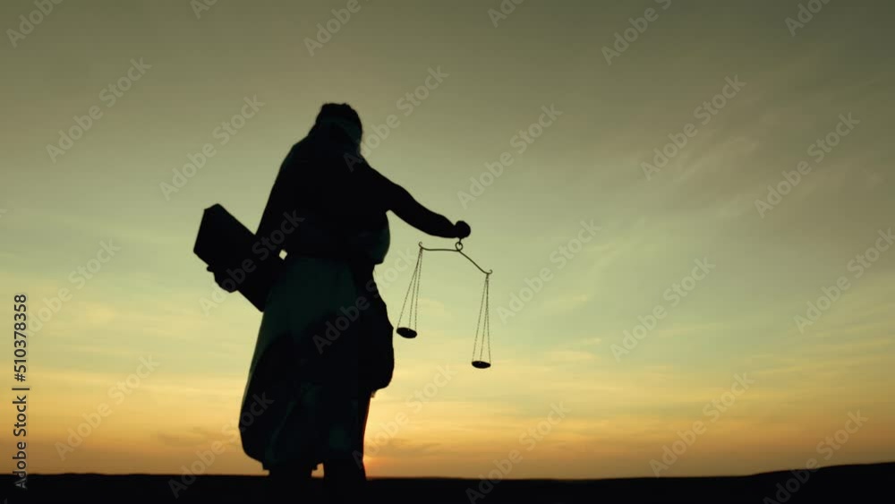 Goddess of justice stands background sunset sky and holds scale and ...