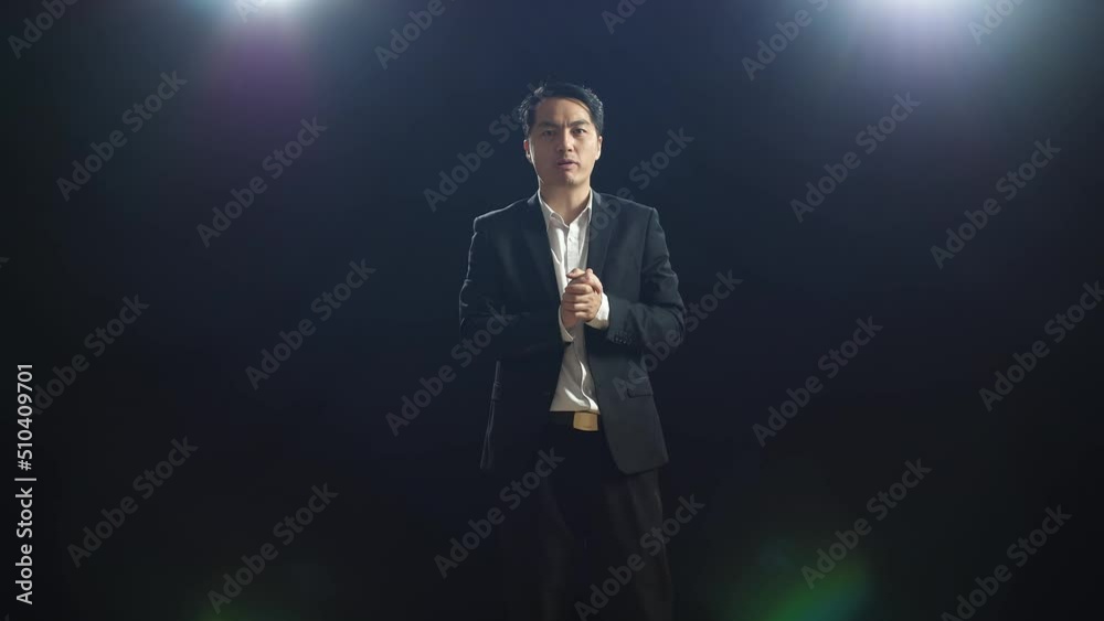 Asian Speaker Man In Business Suit Holding His Hands Together And ...